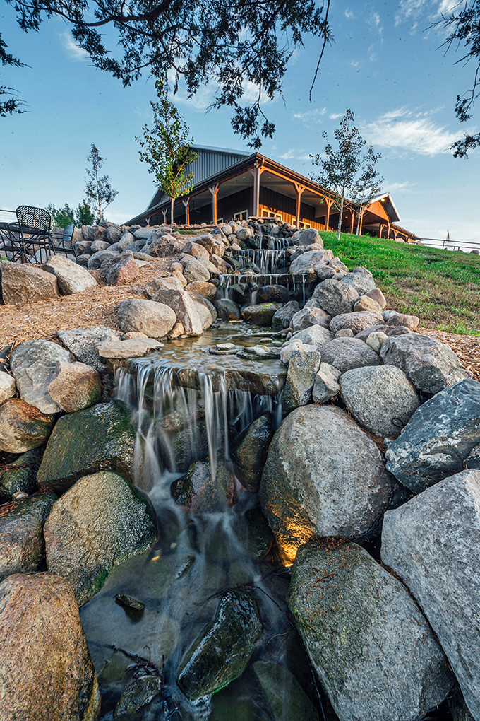 Mother Nature showing off with this picturesque waterfall at The Junto Winery &ndash; where conversations flow as smoothly as the cascading water.