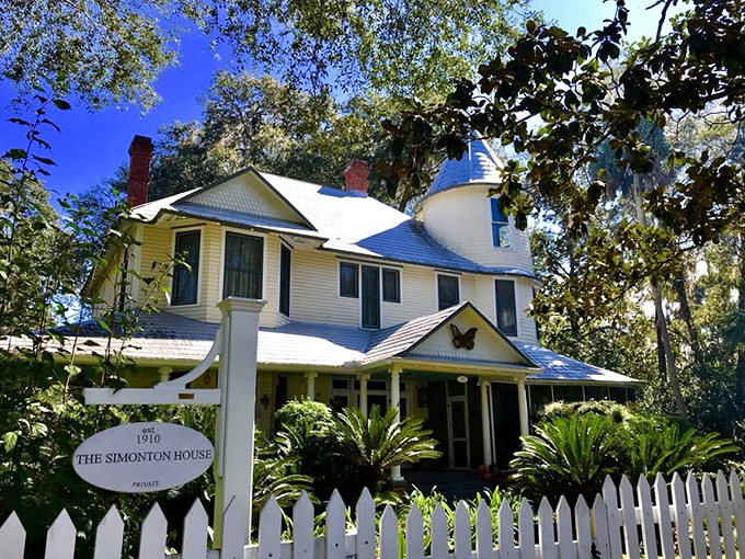 The Simonton House stands proudly behind its white picket fence, looking like it's waiting for Mark Twain to stop by for afternoon tea.