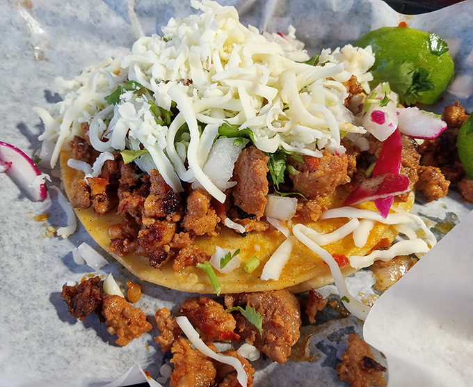 A tostada that's dressed better than most people at a wedding, topped with a confetti of fresh ingredients.
