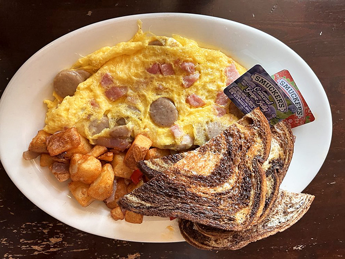 An omelet that's having an identity crisis in the best possible way&mdash;packed with sausage, ham, and potatoes, it's breakfast that eats like dinner.