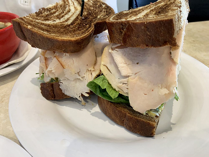 This turkey sandwich isn't playing around—thick-cut marble rye embracing layers of meat with the confidence of a deli that knows its business.