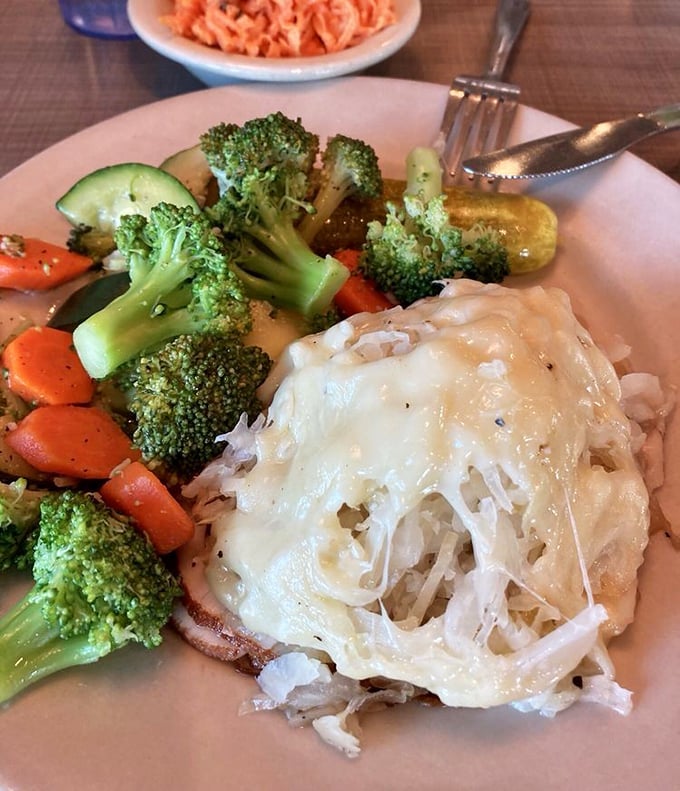 A vegetable oasis! Crisp broccoli and carrots accompany a cheese-blanketed protein, proving that balance is possible even in deli paradise.
