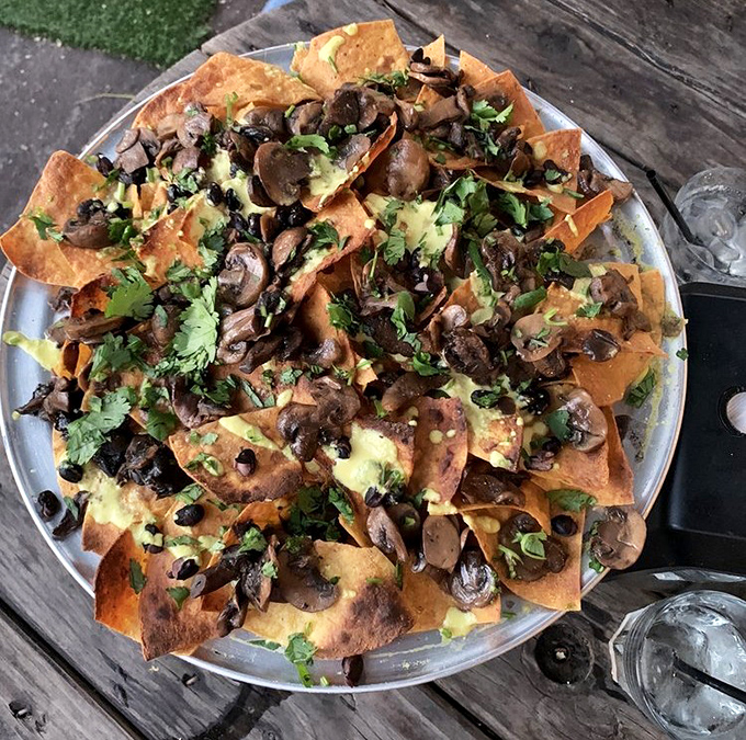 Mushroom magic on corn chips! This vegan-friendly nacho platter proves plant-based can be just as indulgent as its meaty counterparts.