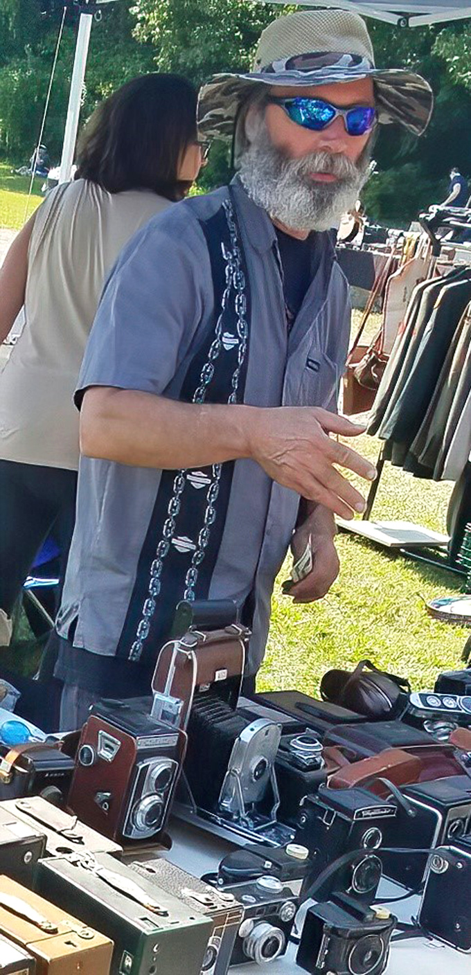 The serious collectors arrive with sunglasses and keen eyes, examining vintage cameras with the focus of diamond appraisers.