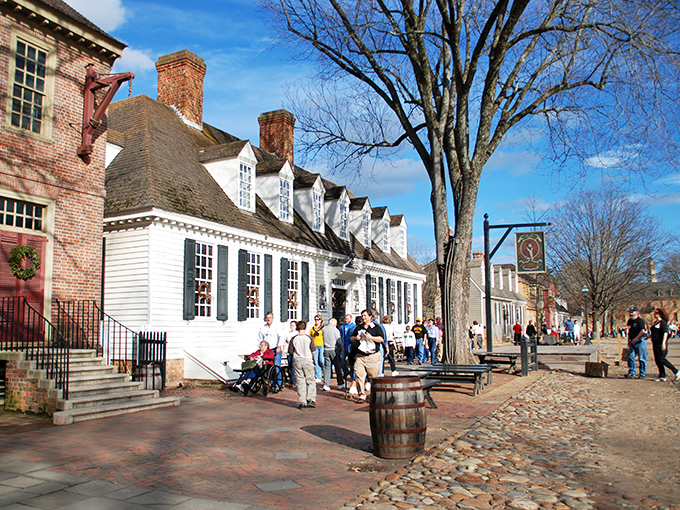 Colonial shopfronts with their distinctive dormers and chimneys create the perfect backdrop for modern visitors exploring a world without Amazon Prime or DoorDash.