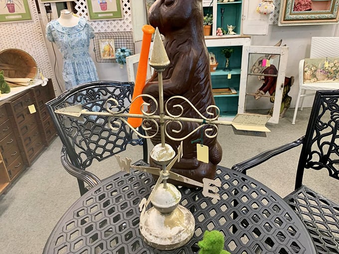 A wrought iron weathervane and vintage patio set create the perfect conversation corner. Mid-century design meets outdoor charm.