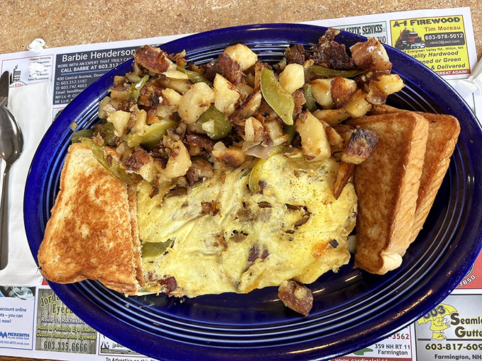 An omelet that's seen things—mainly cheese, peppers, and enough fillings to make you wonder how they folded it without supernatural assistance.