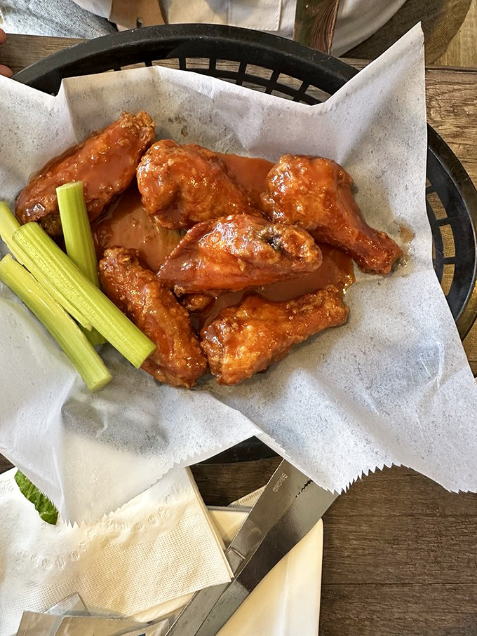 Buffalo wings arranged with military precision, flanked by celery stalks standing at attention. This spicy battalion is ready for duty.