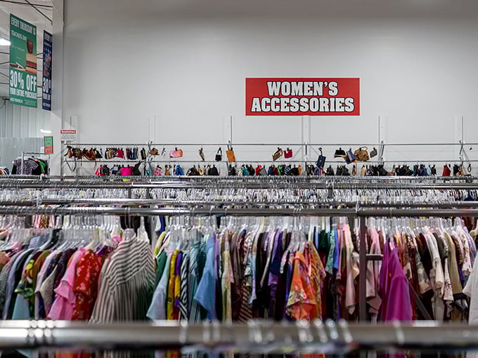 The accessories section: where yesterday's statement pieces await tomorrow's fashion revolutionaries. Handbags hanging like ripe fruit ready for picking.