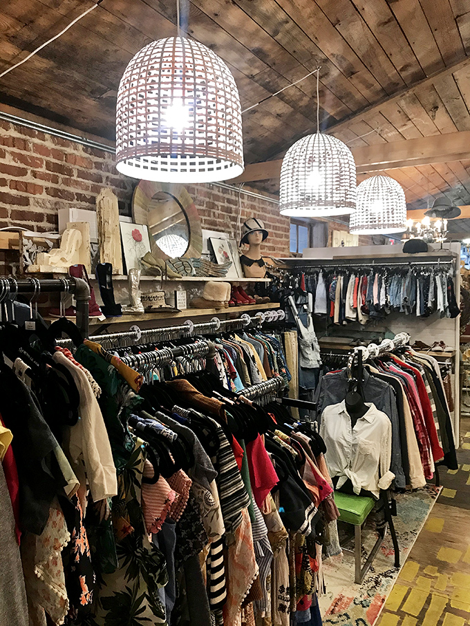 Vintage clothing heaven under woven basket lights. The brick walls and wooden ceiling create the perfect backdrop for fashion treasure hunting.