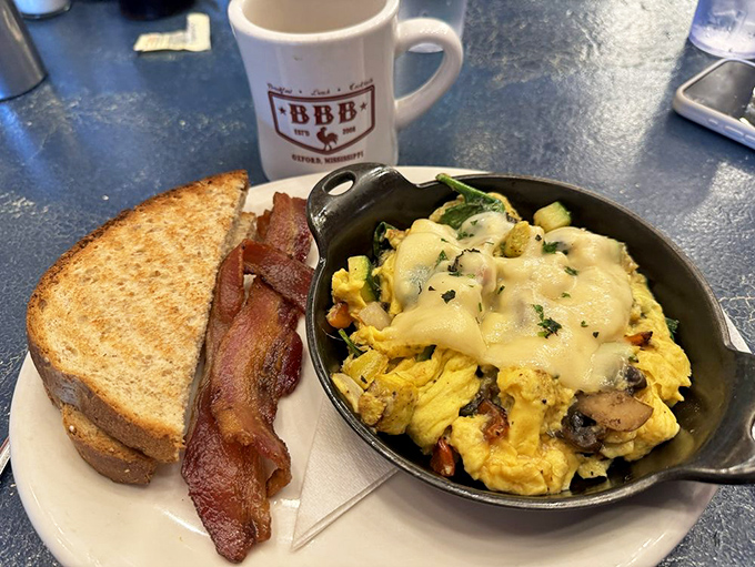 This skillet creation is what breakfast dreams are made of&mdash;eggs, veggies, and cheese in perfect harmony. The toast stands ready for dipping duty.