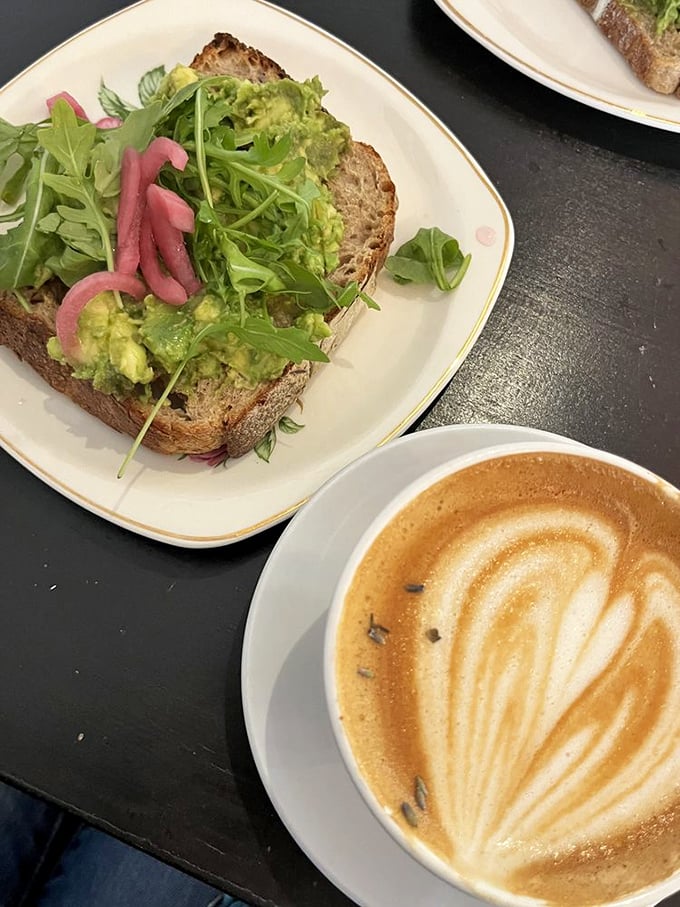 Avocado toast: the dish millennials supposedly sacrificed homeownership for. One bite of this version with its pickled onions and perfect latte pairing explains everything.