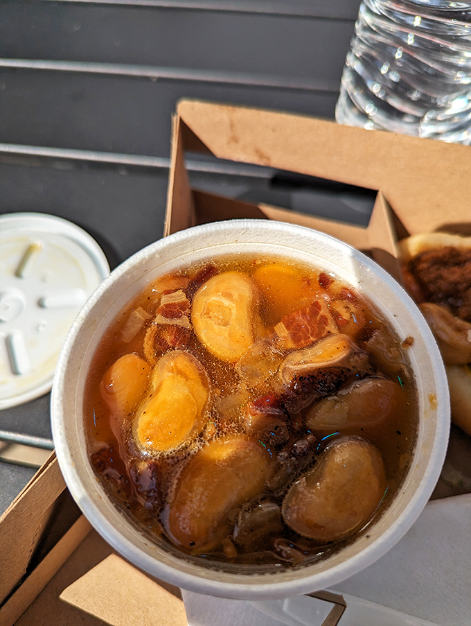 Those baked butter beans aren't just a side—they're practically their own main event, swimming in a savory broth that demands to be savored.