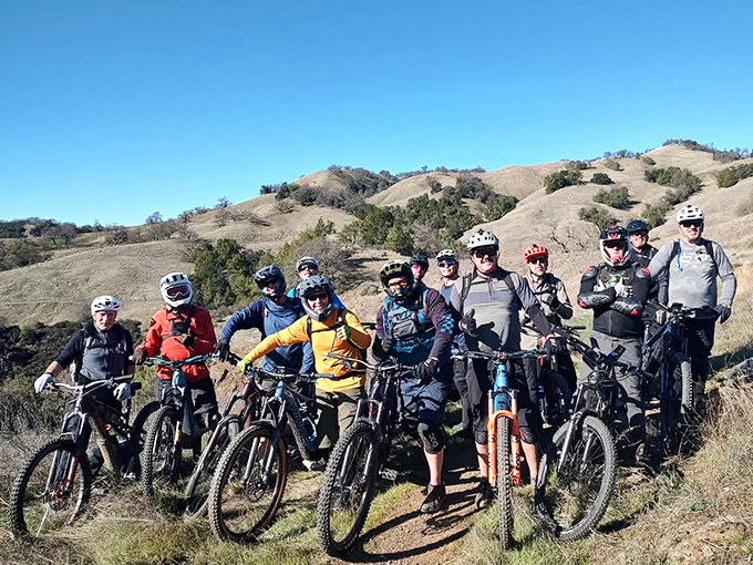 The mountain biking squad, geared up and grinning, ready to tackle trails that would make your Peloton weep with inadequacy.