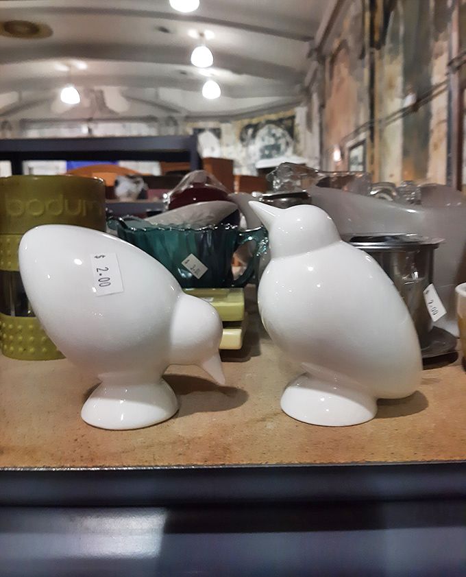 Whimsical white bird figurines stand at attention. Like sentinels guarding the housewares section, these ceramic creatures wait for someone to give them a new perch. 
