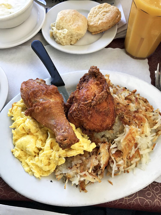 Southern hospitality on a plate: crispy fried chicken, fluffy scrambled eggs, and hash browns that crackle with each forkful.