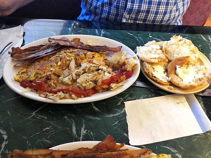 A breakfast symphony with crispy bacon, golden hash browns, and an omelet that clearly went to college. The biscuits? Pure Southern poetry.