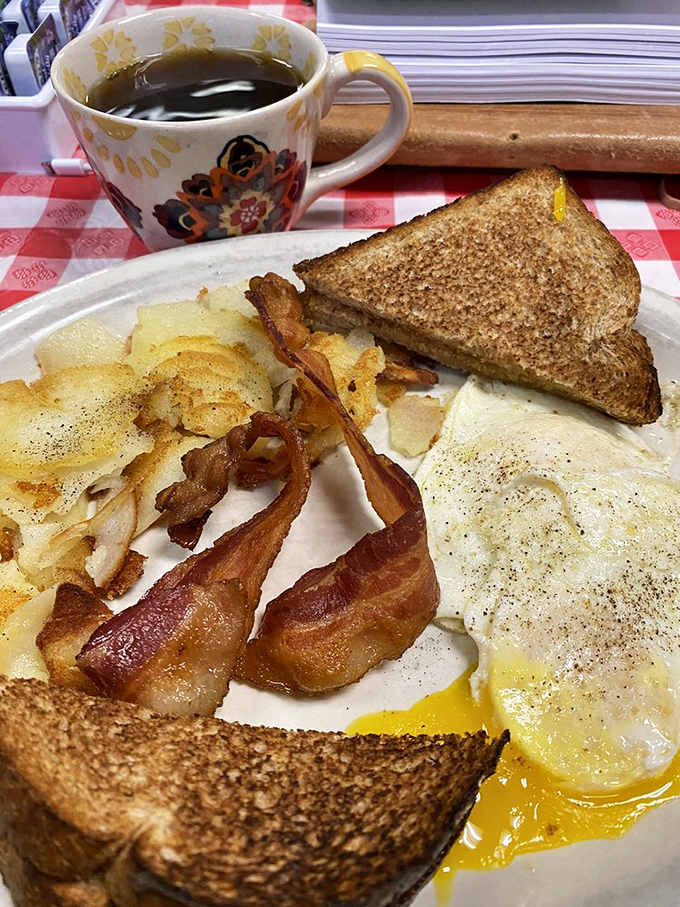 The holy trinity of breakfast perfection: perfectly cooked eggs, crispy-edged bacon, and toast that's achieved that magical golden-brown state that eludes home cooks everywhere.