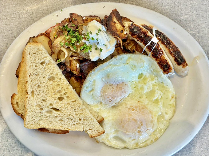 Breakfast perfection: eggs with just-set whites and runny yolks, crispy sausage, and home fries that somehow manage to be both crispy and tender.