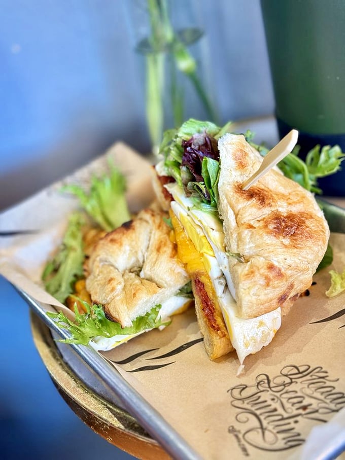 A breakfast sandwich that proves good things come in flaky packages, with a side of greens to convince yourself it's practically a health food.