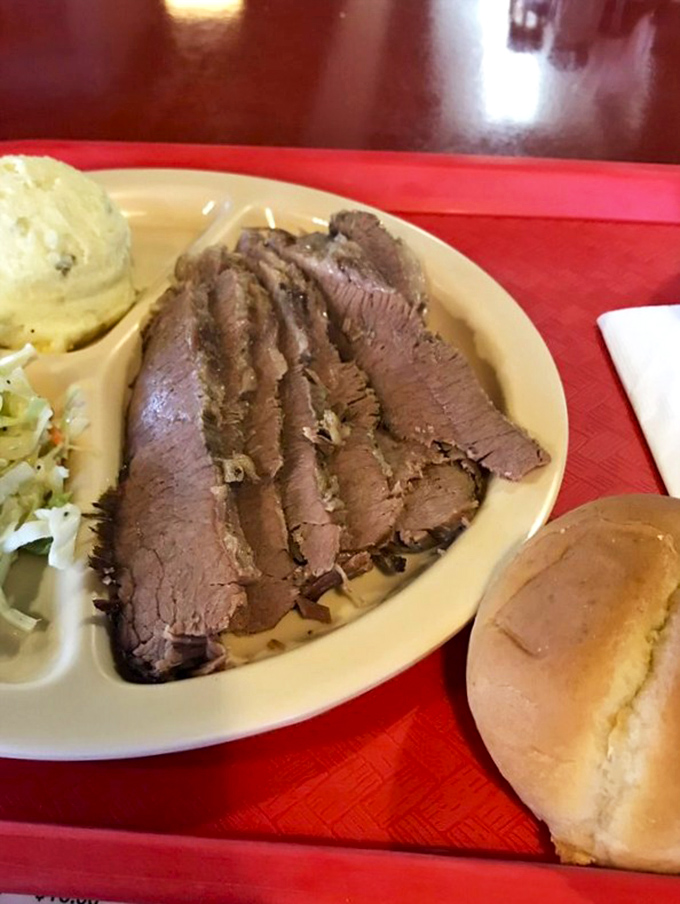 Brisket sliced thin enough to read through, yet substantial enough to change your day. That smoke ring is basically a halo.