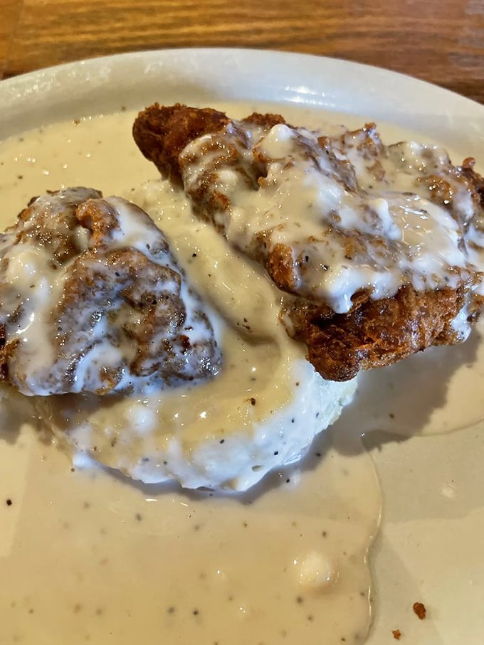 Chicken fried steak swimming in creamy gravy. Southern comfort food that hugs your soul before attacking your arteries.