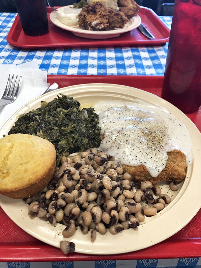 Southern diplomacy on a plate&mdash;black-eyed peas and greens making peace with chicken fried steak under a creamy white gravy treaty.