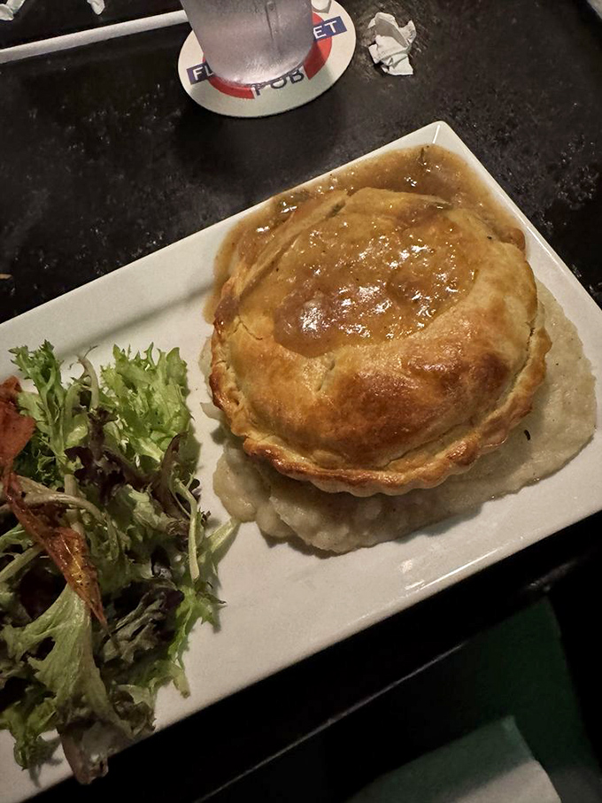 A golden-domed chicken pot pie that could make Paul Hollywood weep. Flaky pastry hiding savory treasures, with a side salad for good measure.