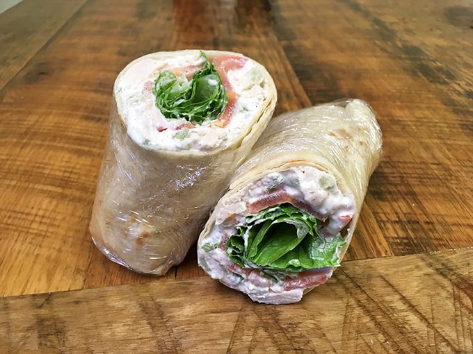 Peek inside this wrap and you'll find a chicken salad that doesn't just speak &ndash; it sings with textures and flavors.