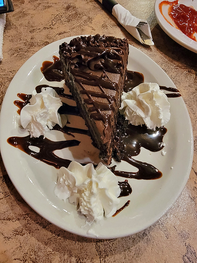 Chocolate cake that doesn't need fancy names or pretentious plating—just four perfect dollops of whipped cream and chocolate sauce for good measure.