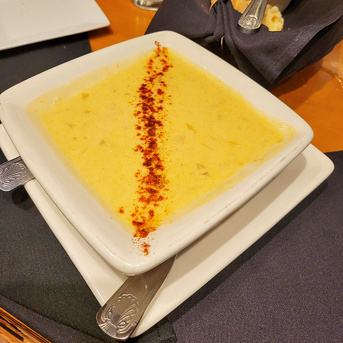 A bowl of sunshine disguised as soup, with a dusting of paprika that's like the culinary equivalent of a perfect sunset.