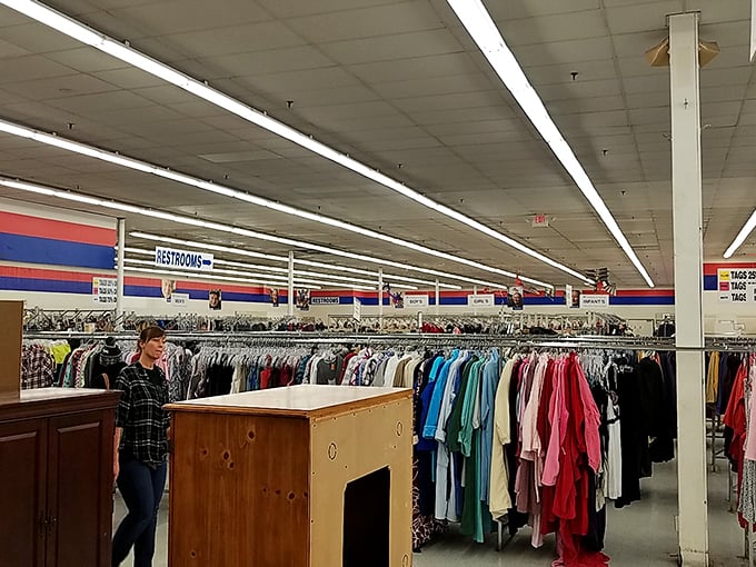 The clothing section stretches toward the horizon, a textile landscape where vintage treasures hide among everyday essentials.