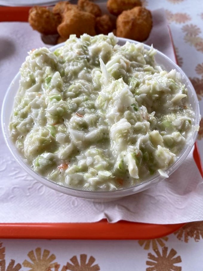 The legendary coleslaw that's worth the drive - fresh, creamy, and absolutely bursting with flavor.