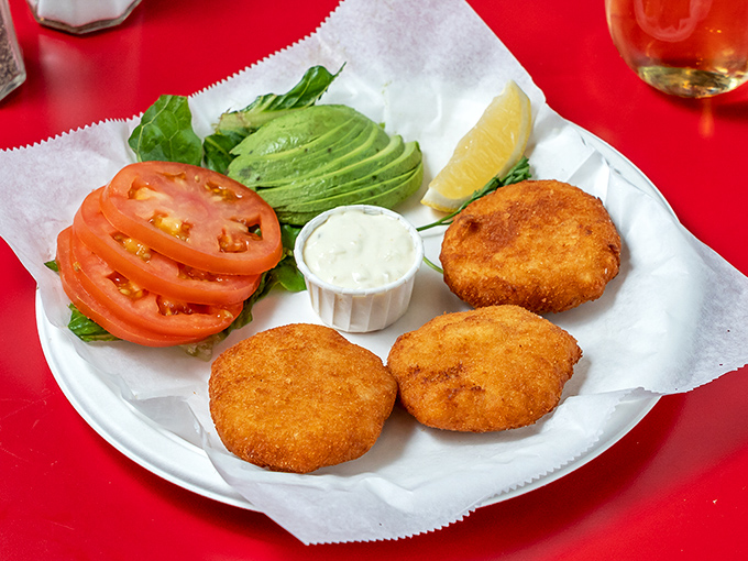 The legendary crab cakes &ndash; golden-crisp exterior giving way to sweet, tender crabmeat within. Like finding treasure on a paper plate.