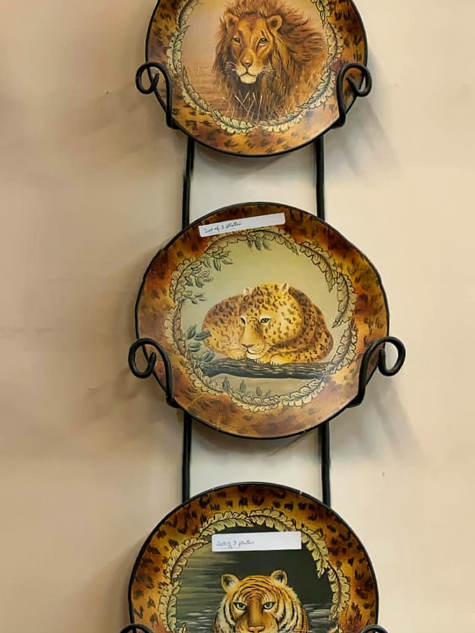 A trio of wild cat decorative plates – because nothing says "sophisticated collector" quite like majestic felines displayed on your dining room wall.