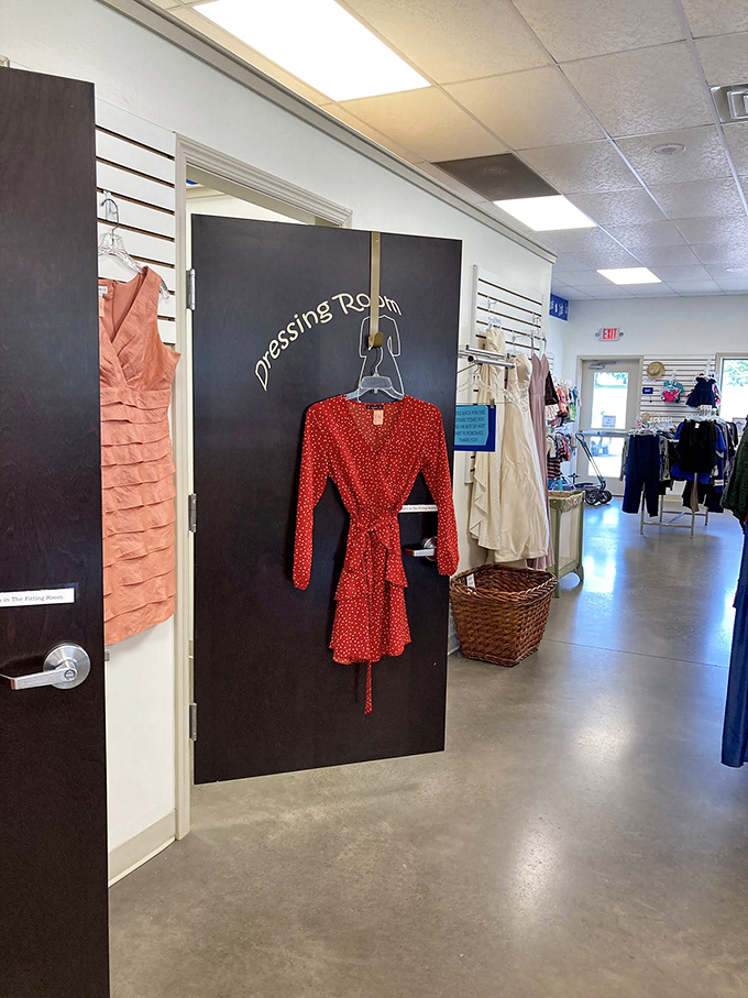 The dressing room beckons with a cherry-red dress that whispers, "Try me on and transform your Tuesday into something special."