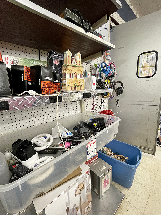 The electronics corner: where yesterday's gadgets await resurrection. That model cathedral adds an unexpected touch of architectural whimsy.