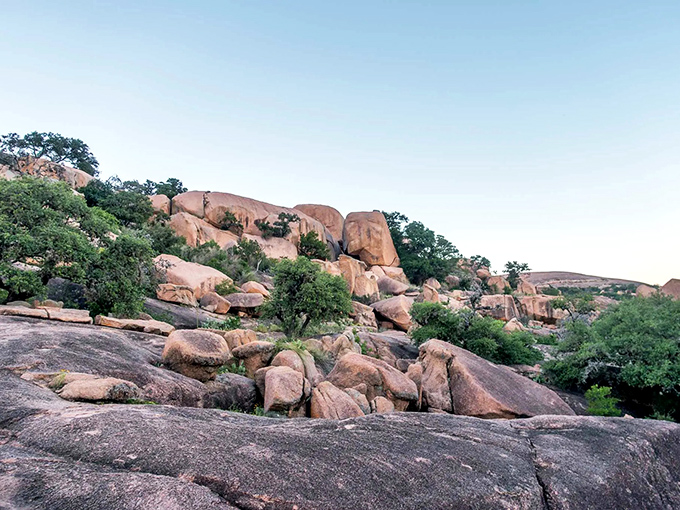 Enchanted Rock rises from the landscape like nature's monument, a pink granite dome that's been drawing hikers and dreamers for generations.