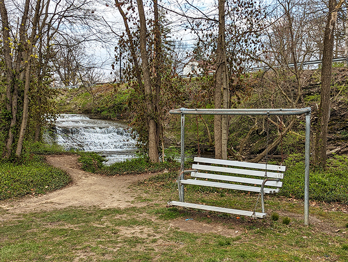 Nature's version of a spa day: a gentle waterfall, a swinging bench, and absolutely zero notifications pinging for your attention.