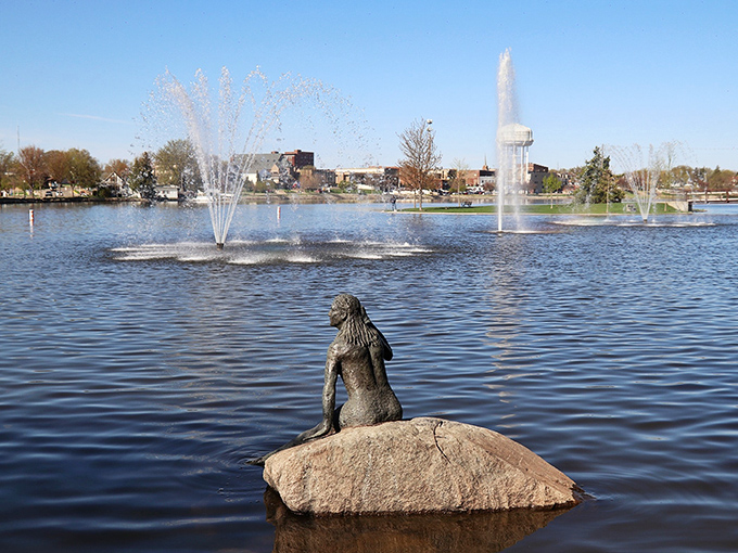 The iconic mermaid statue watches over Fountain Lake's dancing waters, creating a postcard-perfect scene that locals casually call "just another Tuesday."