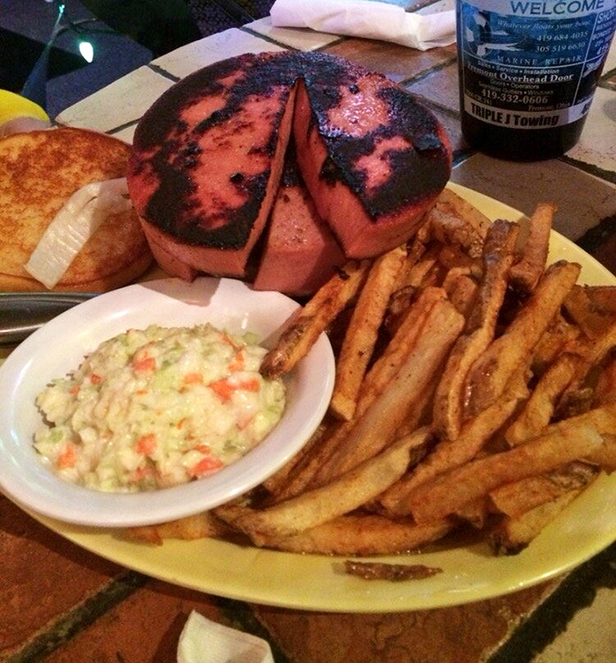 This isn't just a sandwich; it's a pink disc of nostalgia transformed into a charred masterpiece. Comfort food that hugs your arteries with delicious abandon.