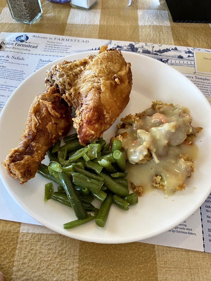 Fried chicken so golden and crispy it deserves its own trophy, nestled beside stuffing that could make a vegetarian temporarily reconsider their life choices.
