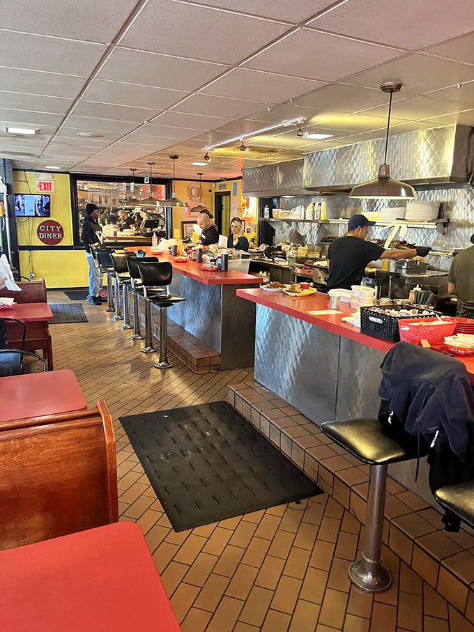 The counter offers front-row seats to the breakfast symphony, where coffee refills flow like conversation.