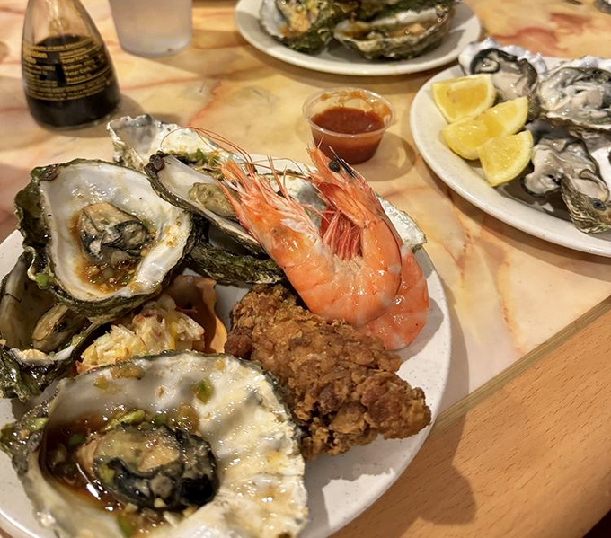 A plate that answers the eternal question: "Why choose between oysters, shrimp, and fried chicken when you can have it all?"