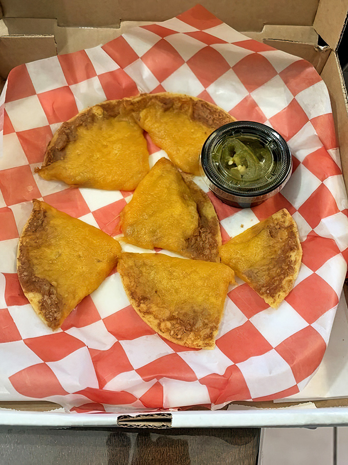 These aren't your ballpark nachos. Each triangular vessel carries a perfect balance of beans, cheese, and just enough structural integrity for the journey to your mouth.