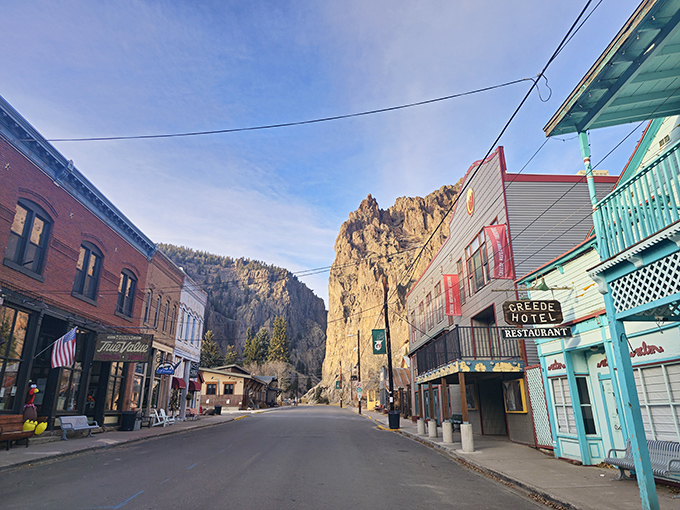 Morning light bathes Creede's historic district in golden warmth, with the iconic Creede Hotel standing ready for another day of hospitality against dramatic canyon walls.