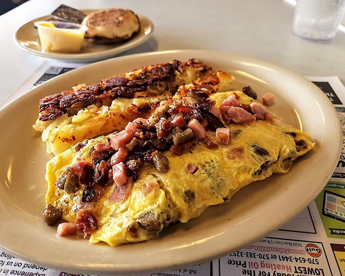 This isn't just an omelet&mdash;it's a protein-packed canvas where ham, mushrooms and cheese perform a beautiful morning ballet. Paired with crispy bacon, it's breakfast nirvana.