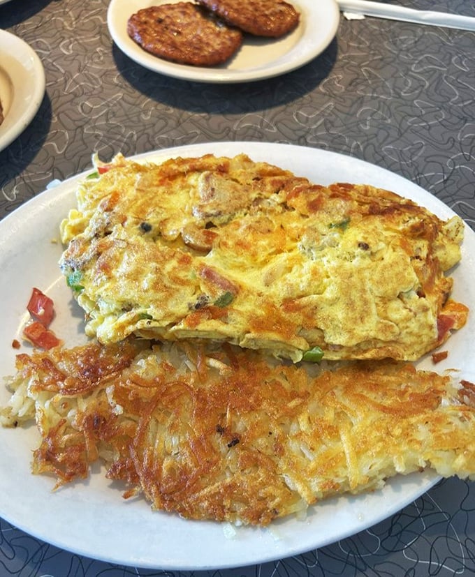 An omelet that's seen the inside of a real skillet, not a microwave, paired with hash browns that crackle with golden perfection.