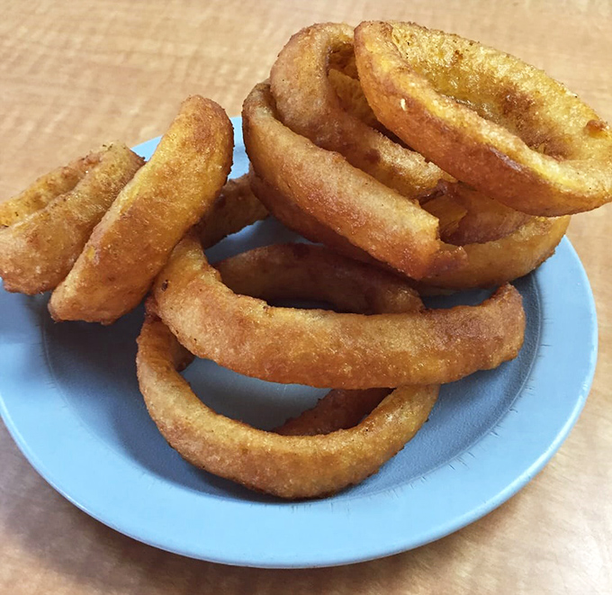Onion rings with the structural integrity of Olympic medals and twice the satisfaction. Golden, crispy circles of joy that put fancy appetizers to shame.