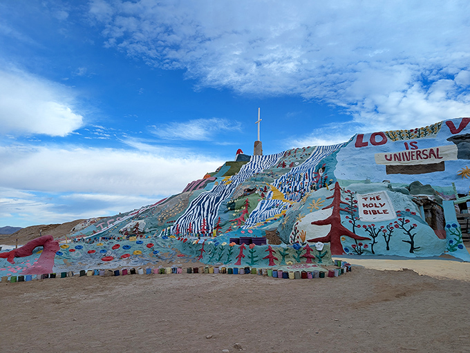 Where the desert meets devotion. The mountain's vibrant blues and reds create a startling contrast against California's endless sky.